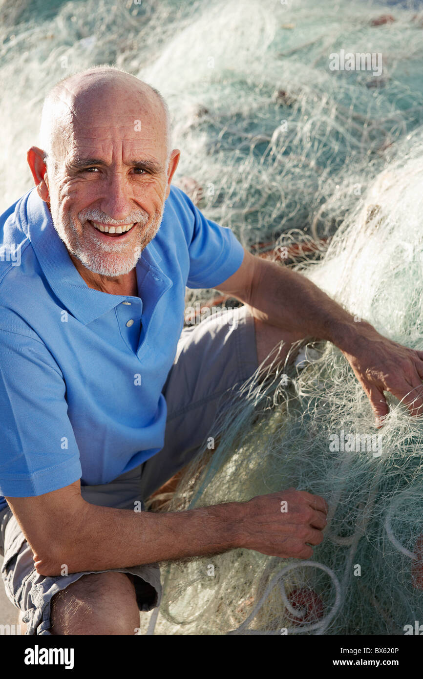 Fisherman preparing fishing nets hi-res stock photography and images ...