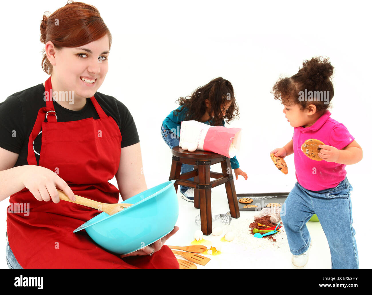 Adorable scene with baby sitter baking cookies with kids over white ...