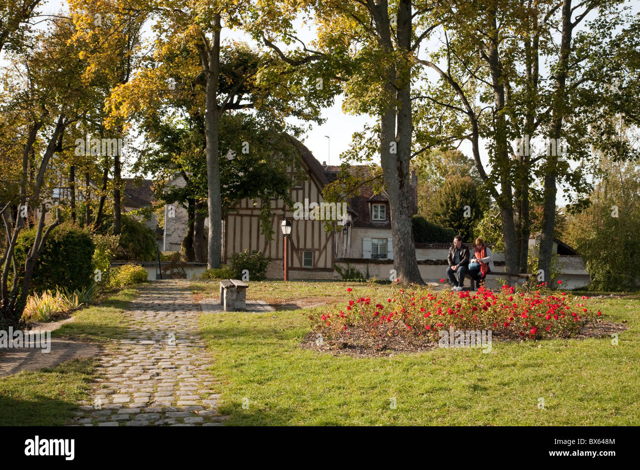 People sitting in Le Jardin des Breban (Breban Garden), the medieval ...