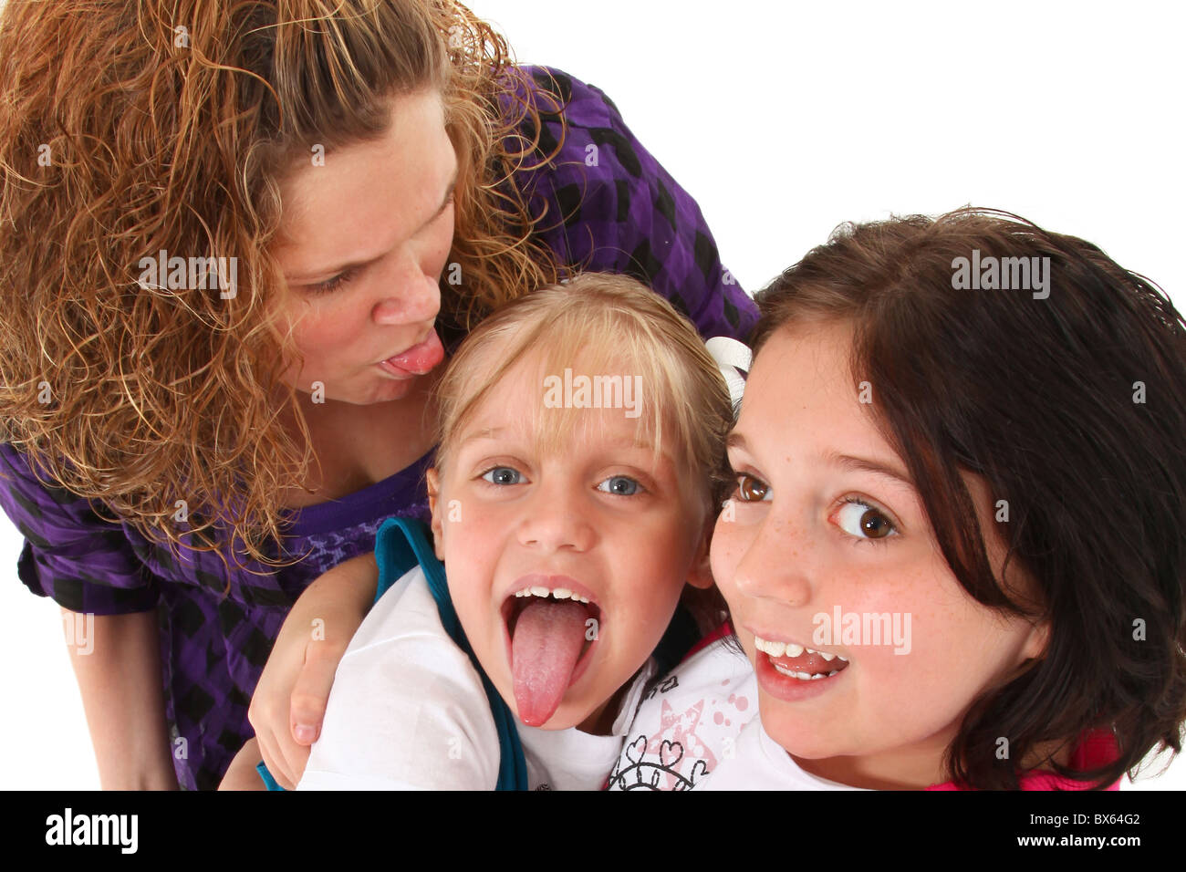 Siblings making silly faces over white background. Top view looking ...