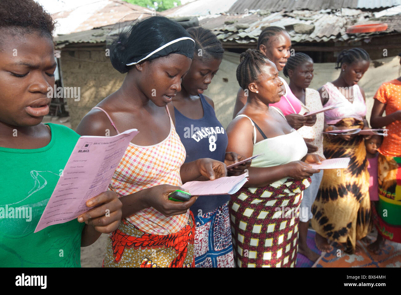 Women attend a community microfinance meeting in Kakata, Liberia, West ...
