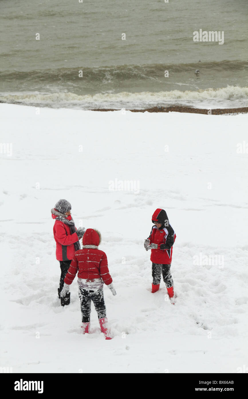 Children play in the snow on Eastbourne Beach, East Sussex, England ...