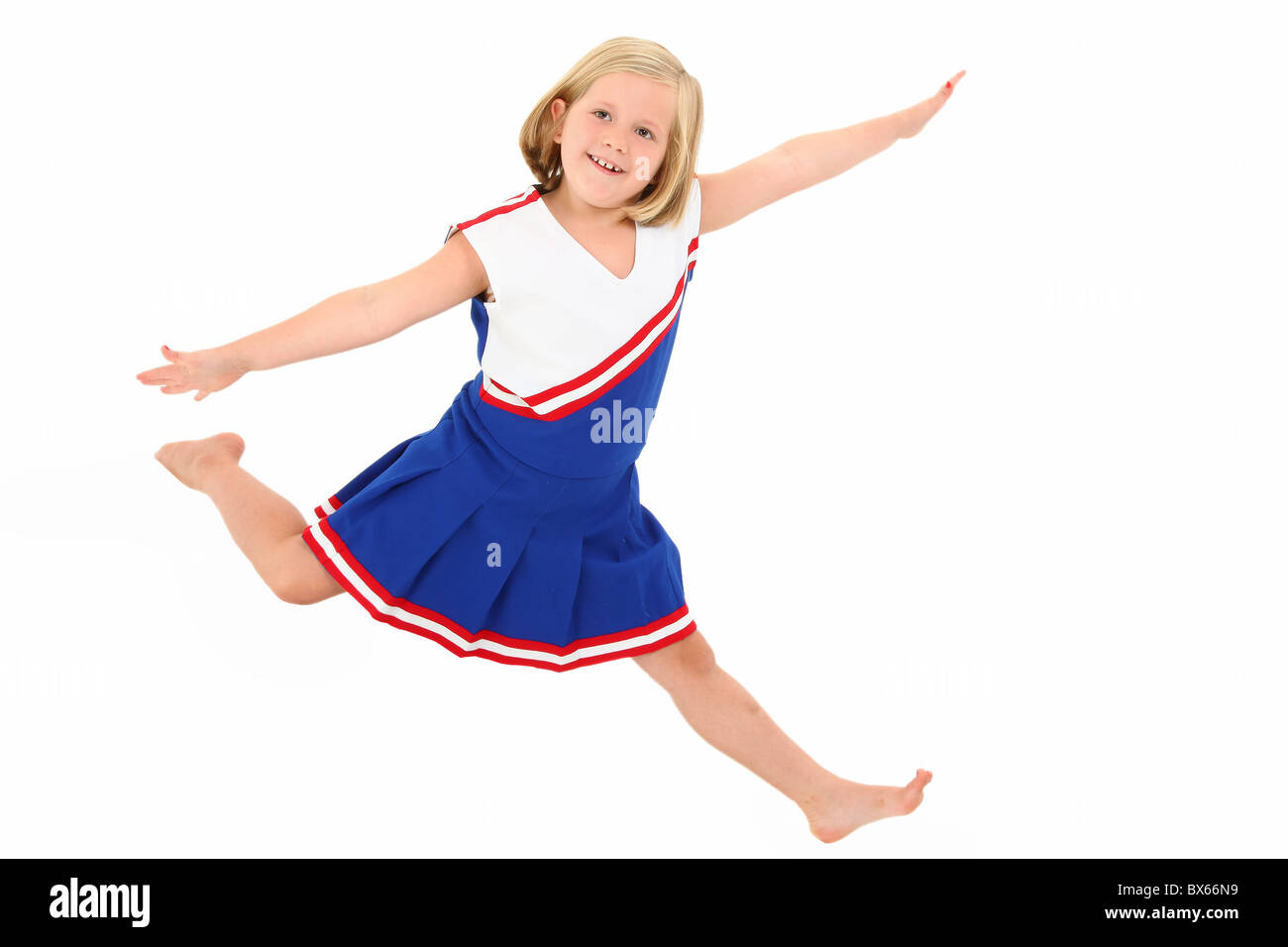 Adorable 7 year old blond american girl in cheerleader uniform barefoot ...