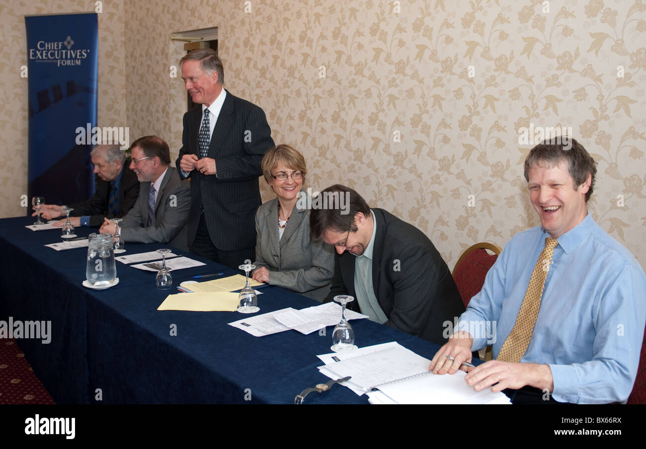 A conference panel sharing an amusing moment Stock Photo - Alamy