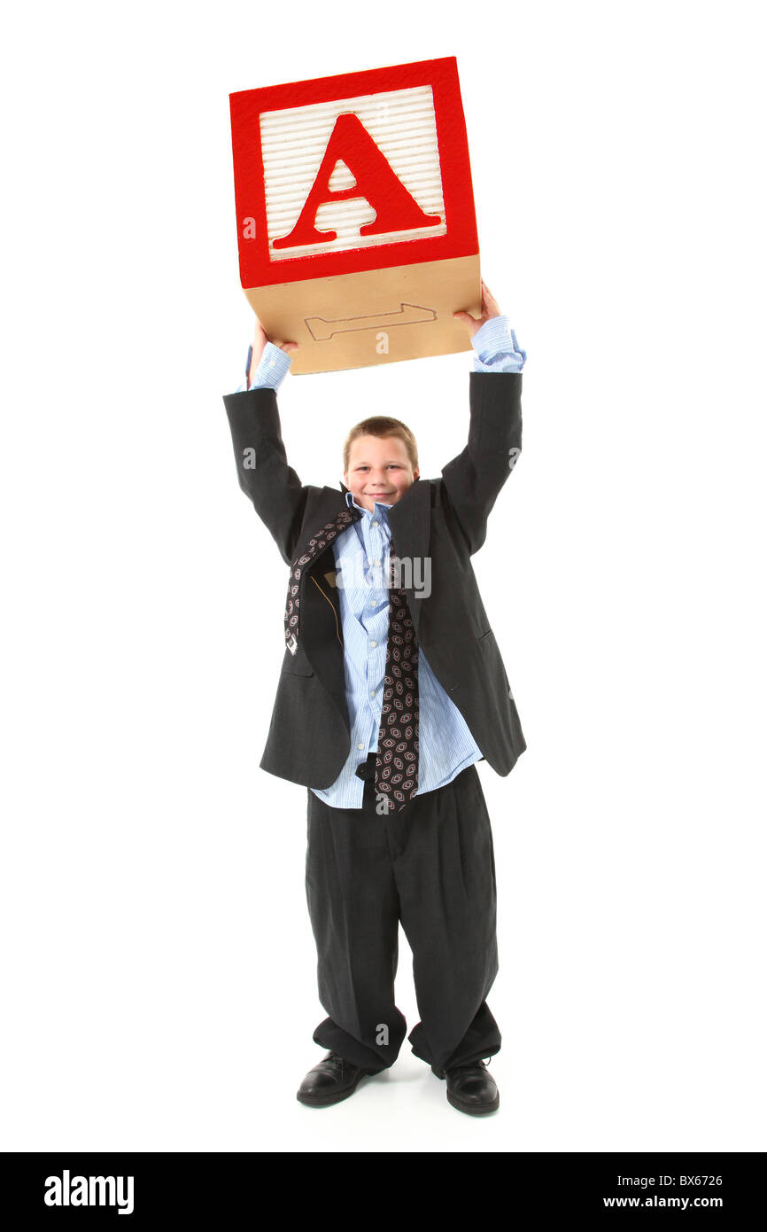 Handsome ten year old boy in over sized suilt holding giant letter A ...