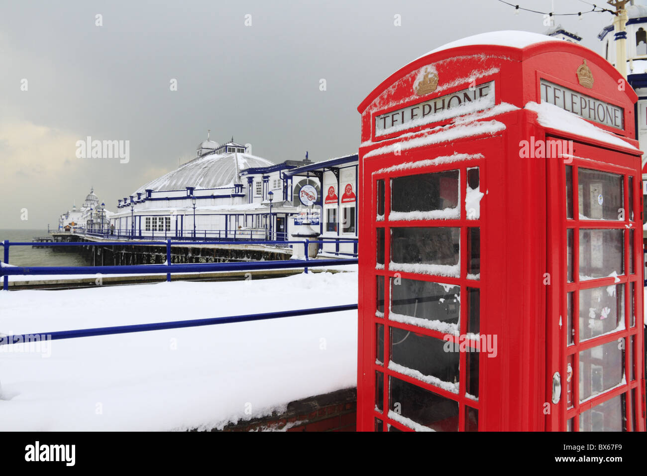 An old red telephone box and Eastbourne Pier in the snow Stock Photo ...