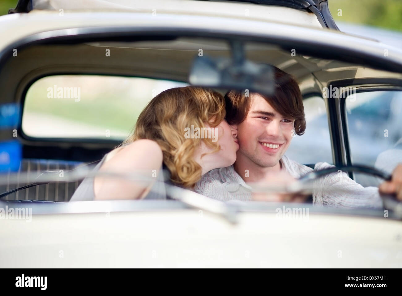 Loving couple in a car Stock Photo - Alamy