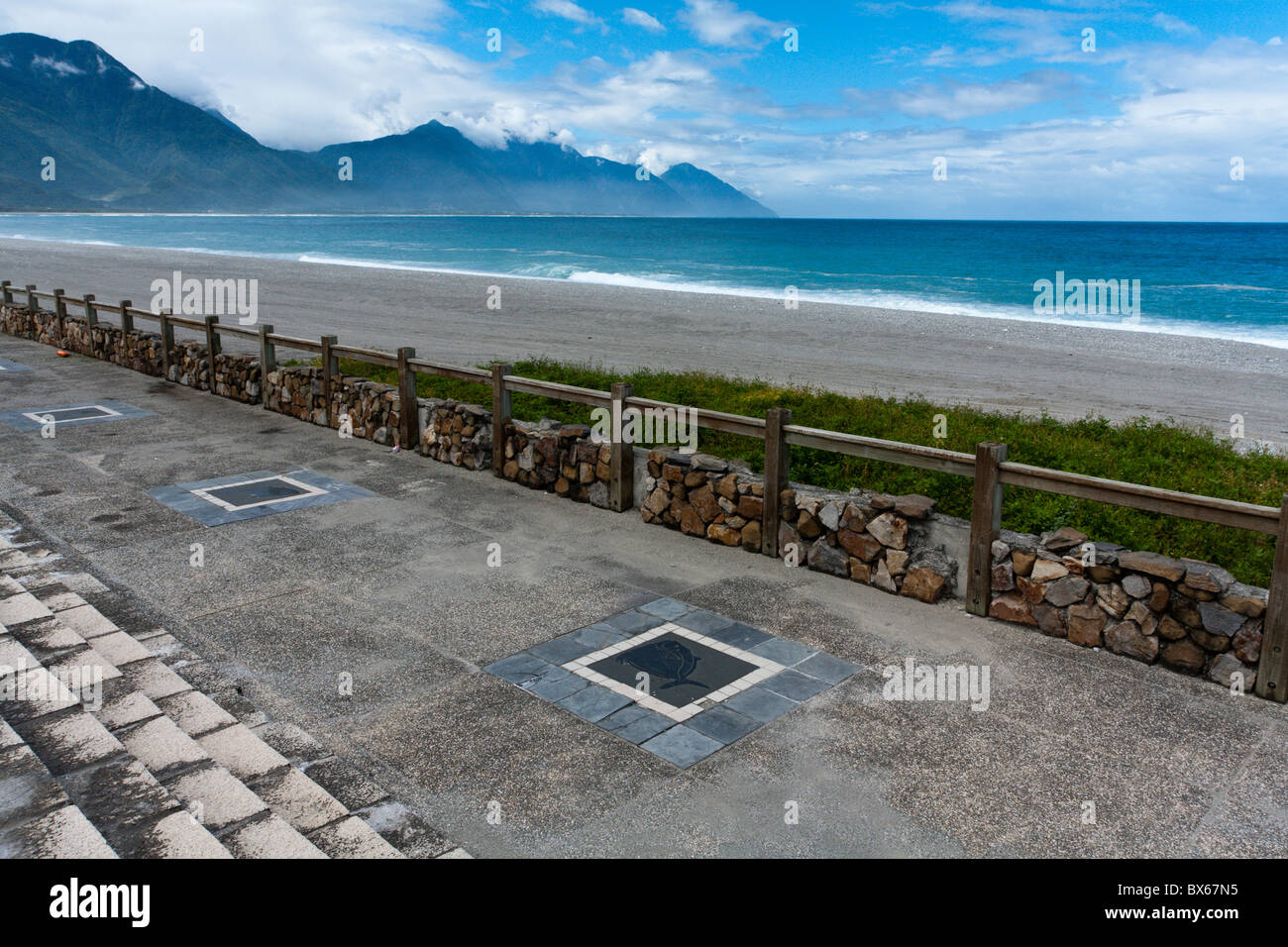 Empty promenade, clear azure waters washing over the pebbles, Central ...