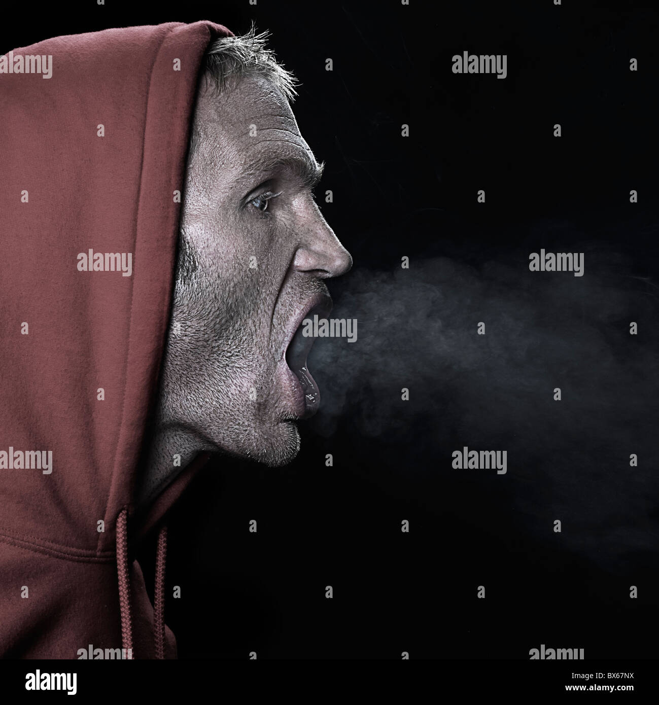 Man breathing out Stock Photo - Alamy