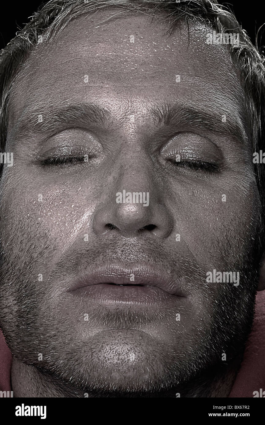 Sweating man with closed eyes Stock Photo - Alamy
