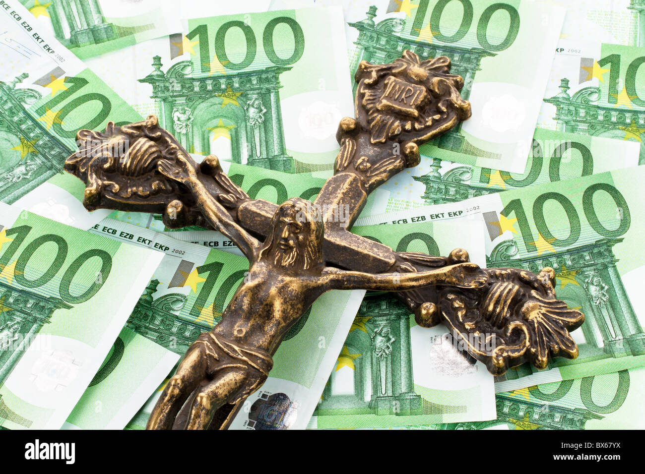 Banknotes and religion symbol photo Stock Photo - Alamy