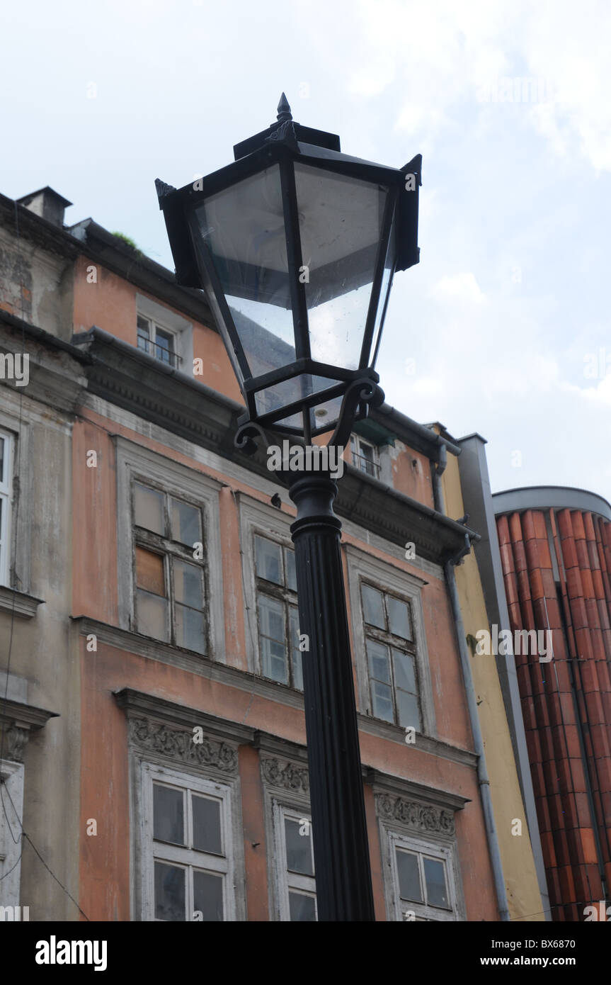 Old lamp post with building behind a street in Krakow old town in ...