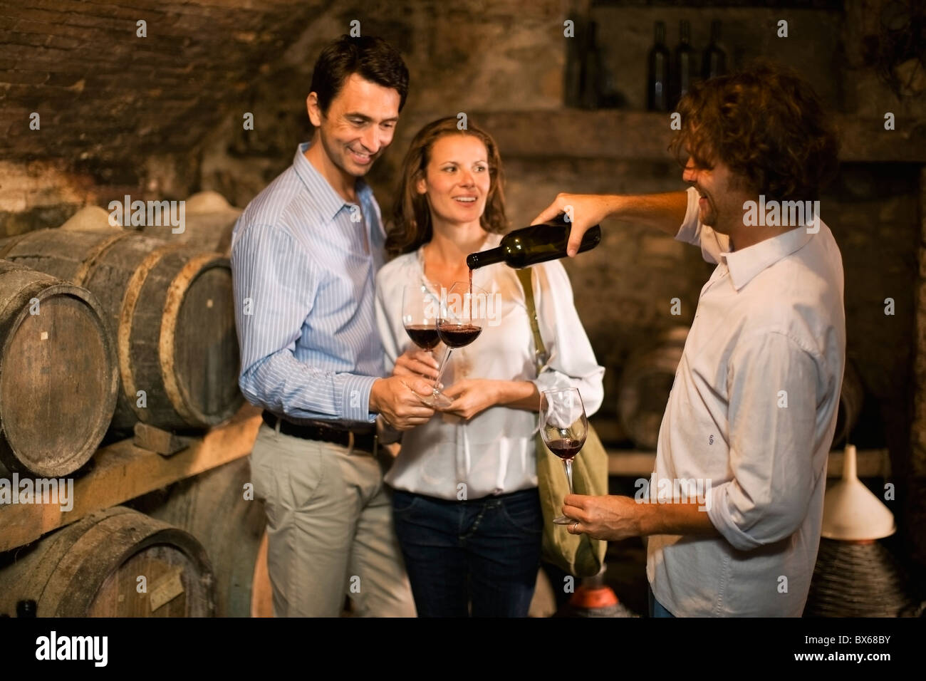 Three people tasting wine Stock Photo - Alamy