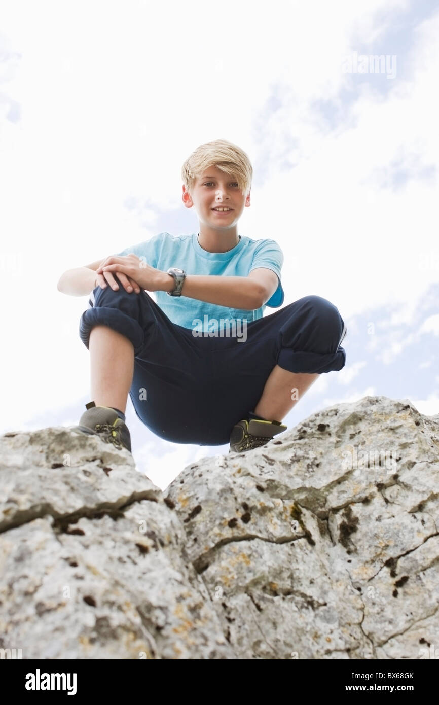 Boy on a rock Stock Photo - Alamy