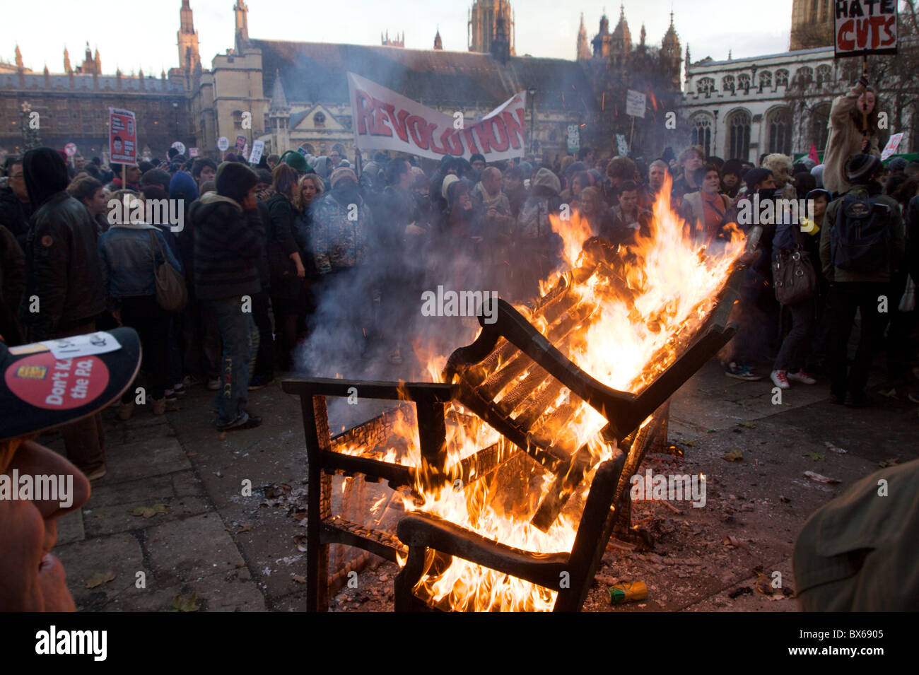 A wooden chair is set on fire as students protest against rise in ...