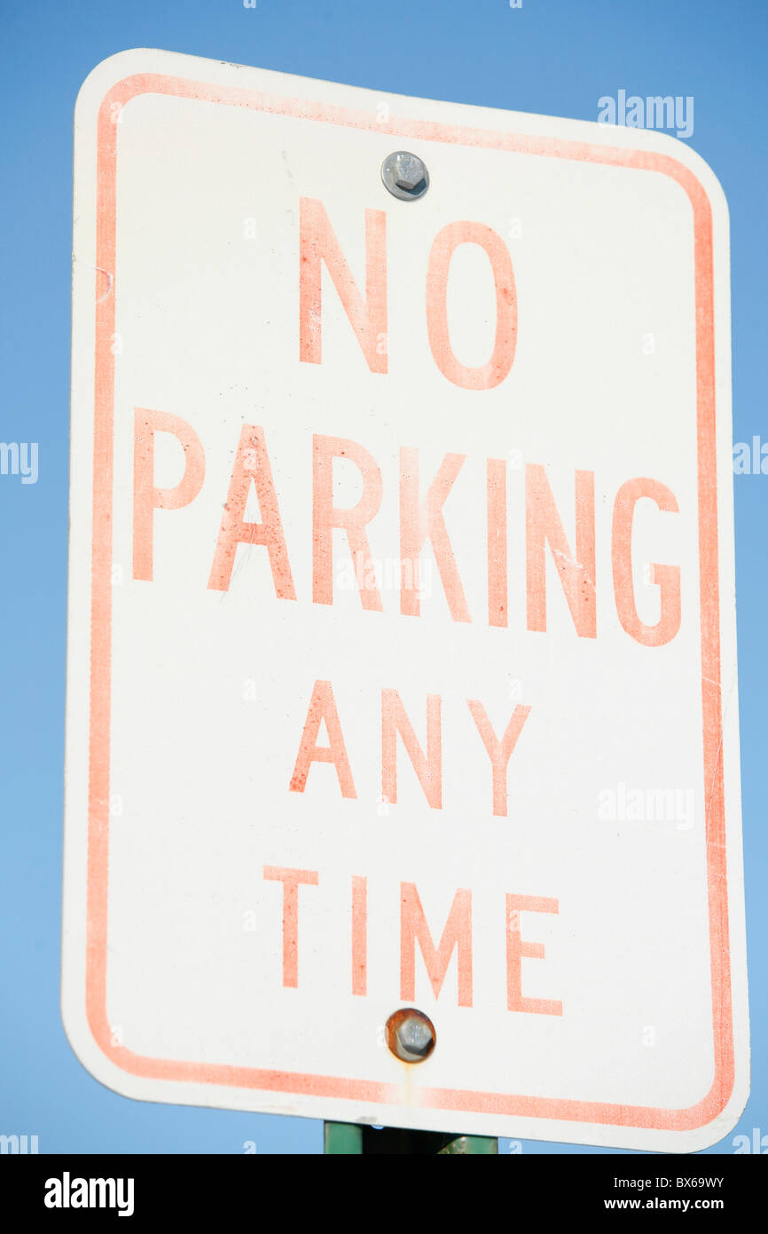 No parking any time faded sign Stock Photo - Alamy