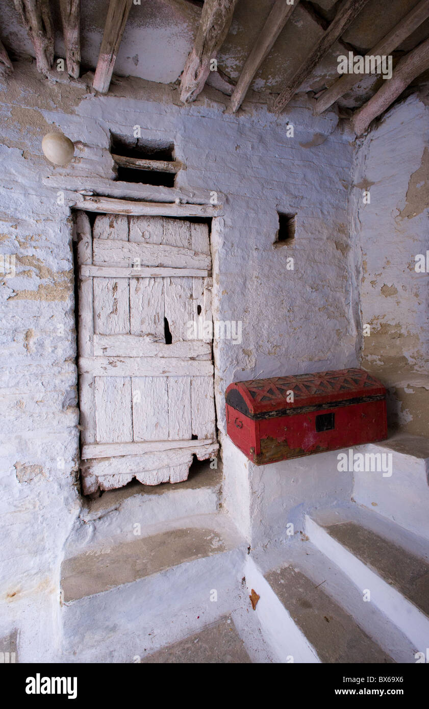 Old wooden door and red chest in a covered alley of Arnados, on the ...