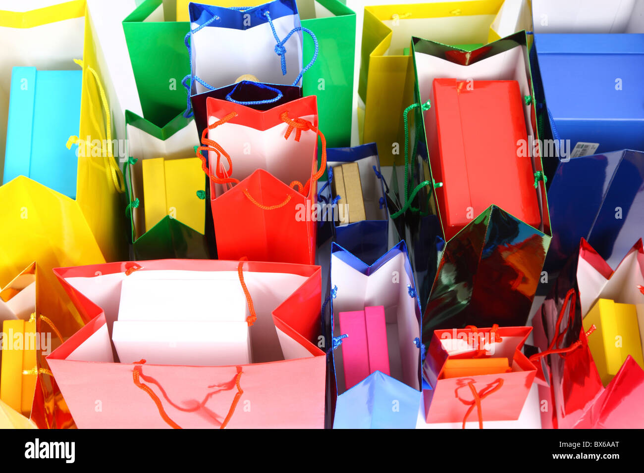 Colorful paper gift bags, filled with cardboard boxes Stock Photo - Alamy