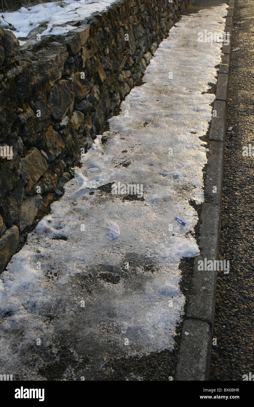 ice and snow on pavement in deiniolen, north wales Stock Photo - Alamy