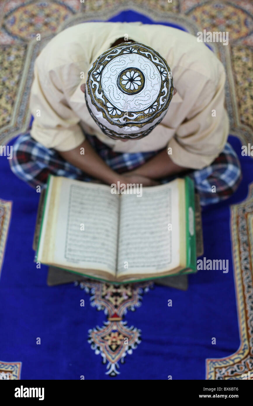 Muslim man reading quran in the mosque hi-res stock photography and ...