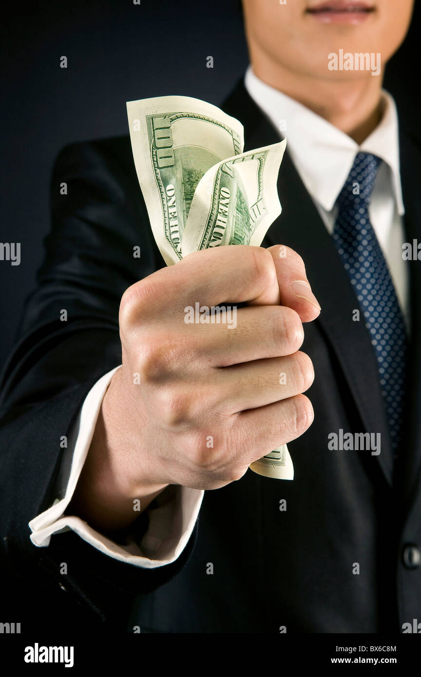 A businessman graping paper money Stock Photo - Alamy