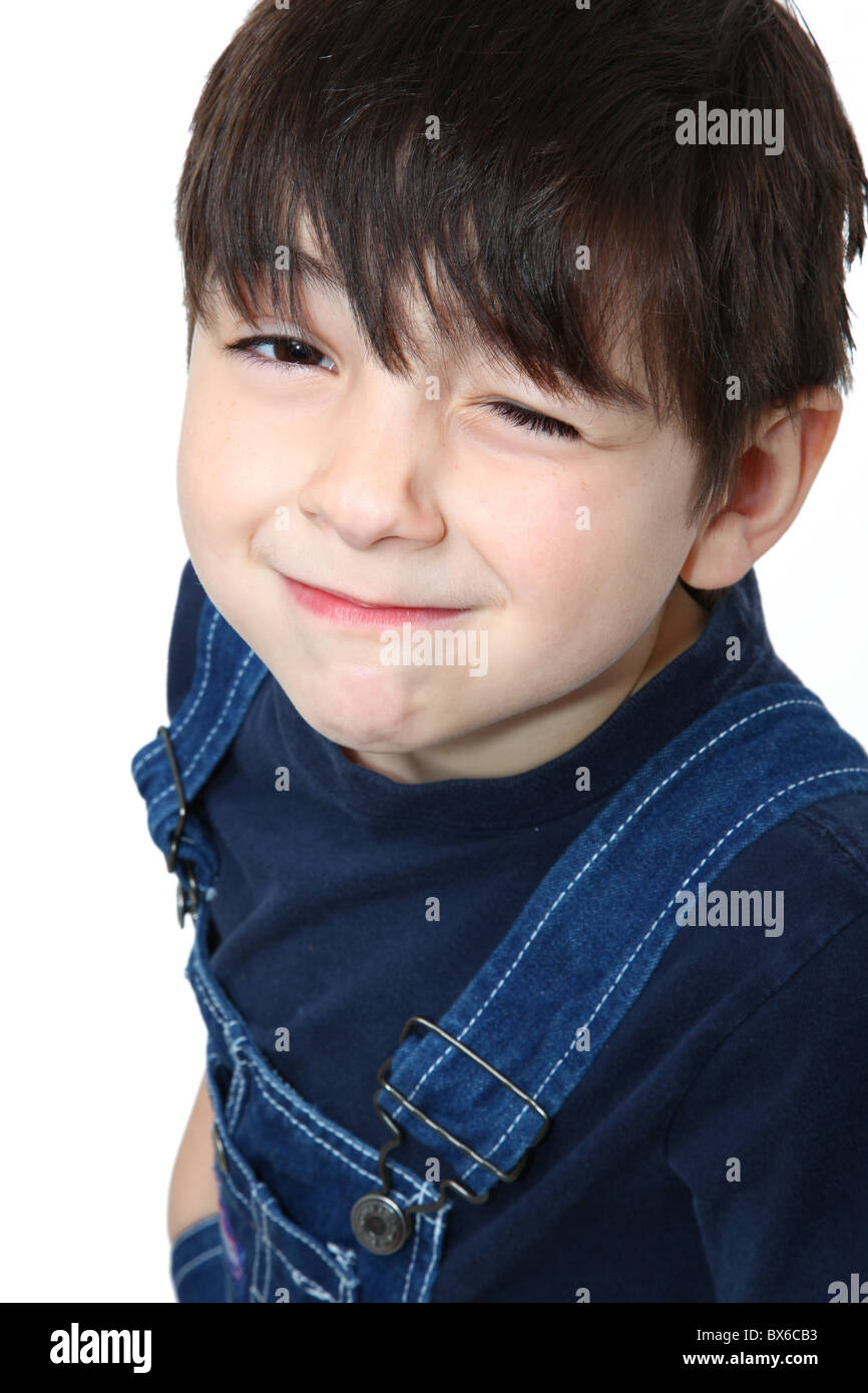 Adorable six year old caucasian boy in overalls winking at camera Stock ...