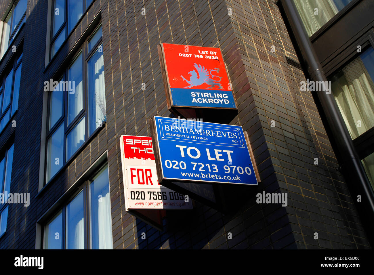 For sale and to let signs outside a block of apartments Stock Photo - Alamy