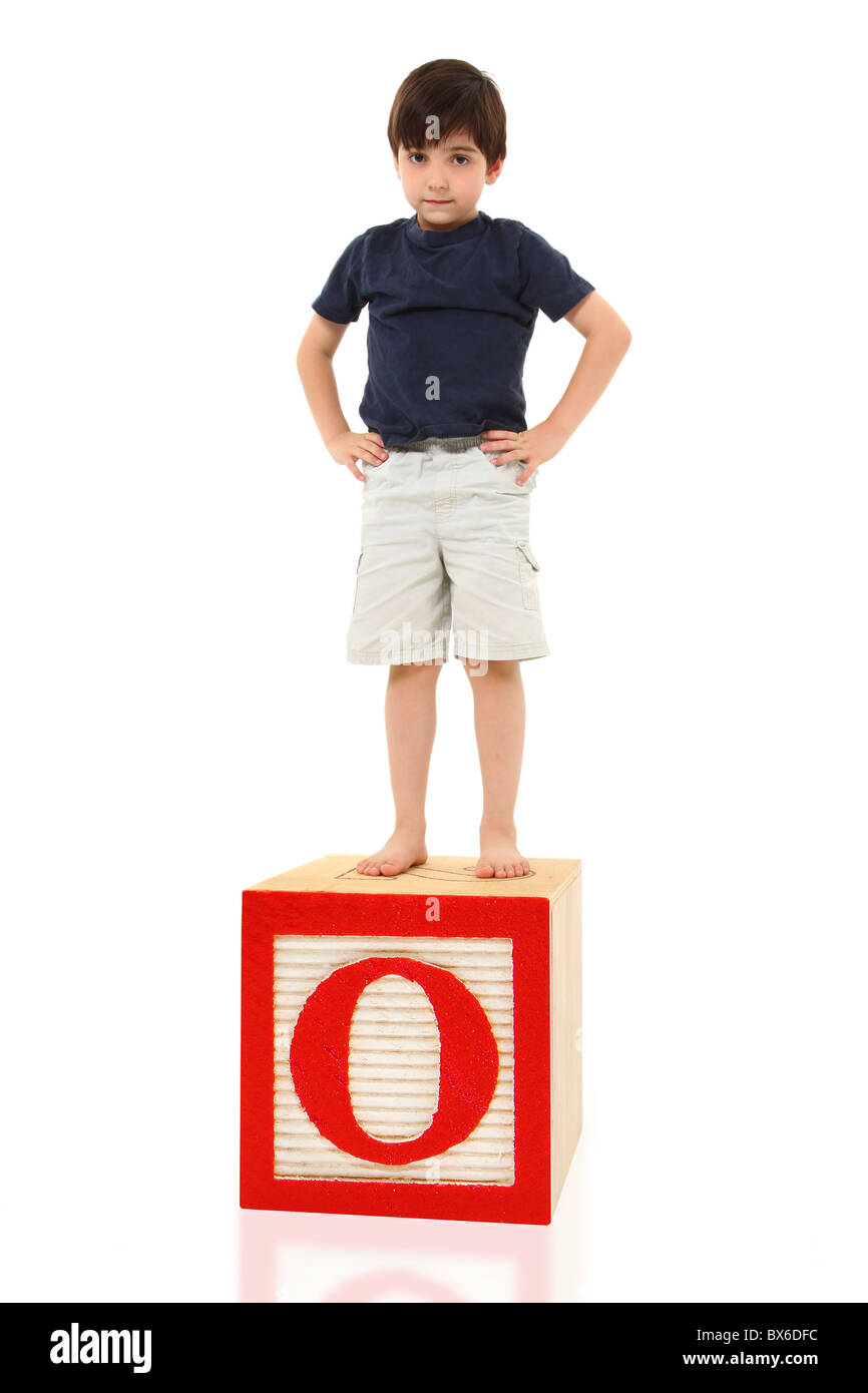 Adorable seven year old french american boy standing on a giant ...