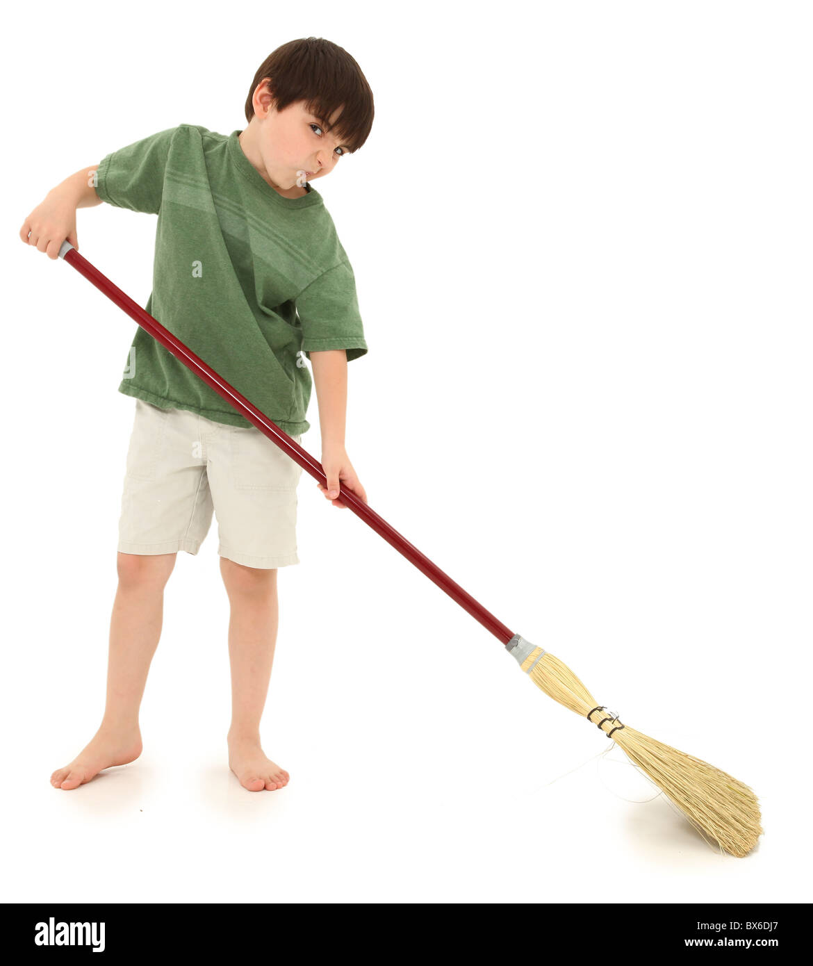 Adorable seven year old french american boy sweeping over white Stock ...