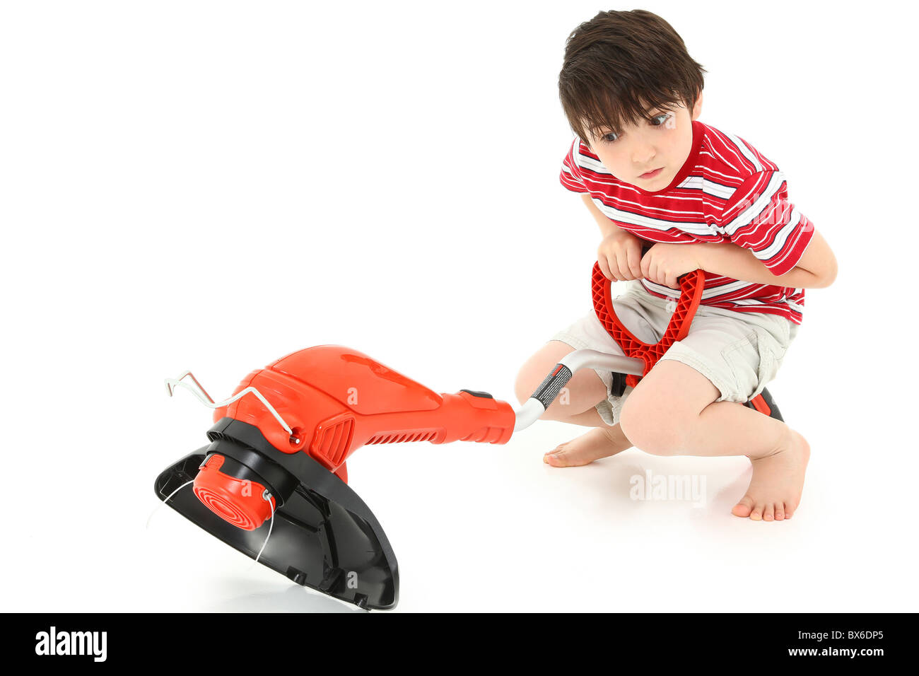 Adorable seven year old french american boy with weed whacker over ...