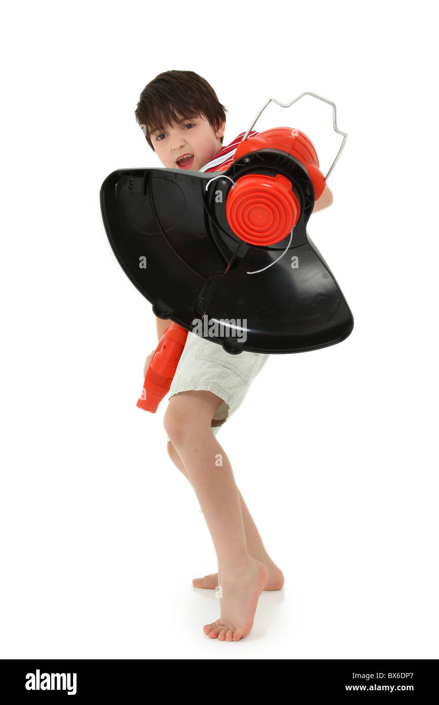 Adorable seven year old french american boy with weed whacker over ...