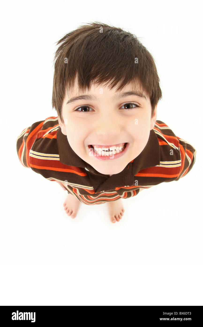 Adorable seven year old french american boy smiling up towards camera ...