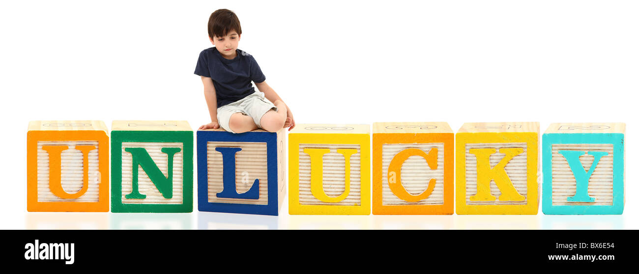 Attractive sad seven year old french american boy sitting on unlucky ...