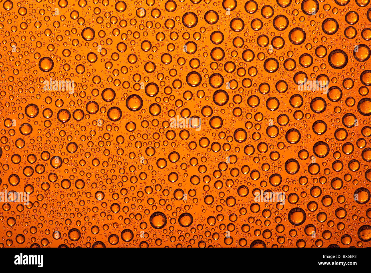 Orange water drop background Stock Photo - Alamy