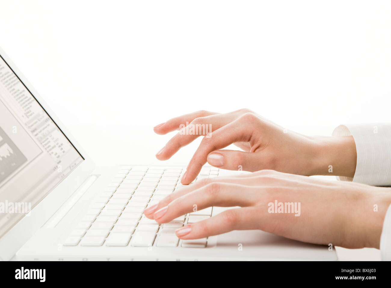 Side view of female hands pressing keys of white laptop keypad Stock ...