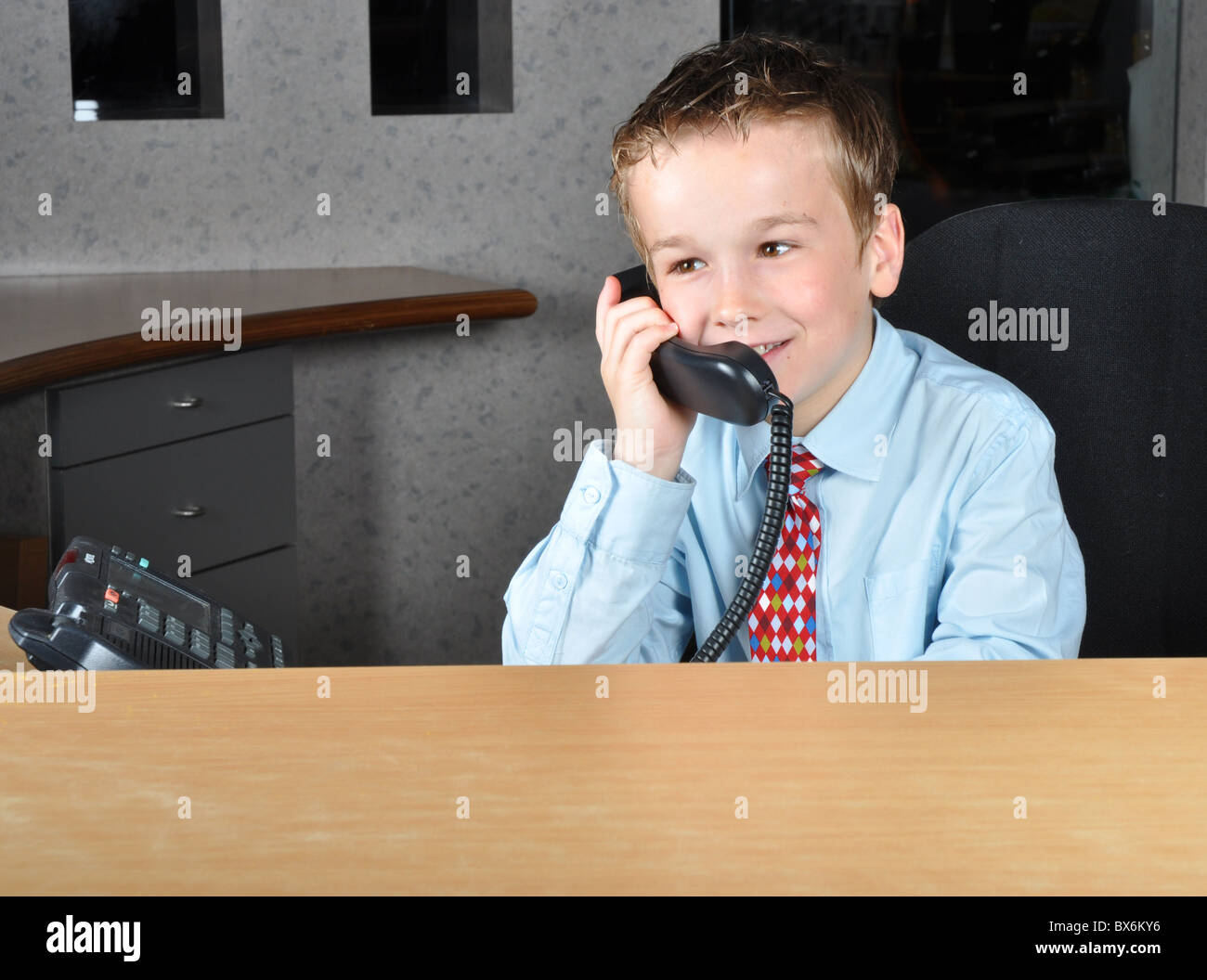 Young men answering the telephone at the reception Stock Photo - Alamy
