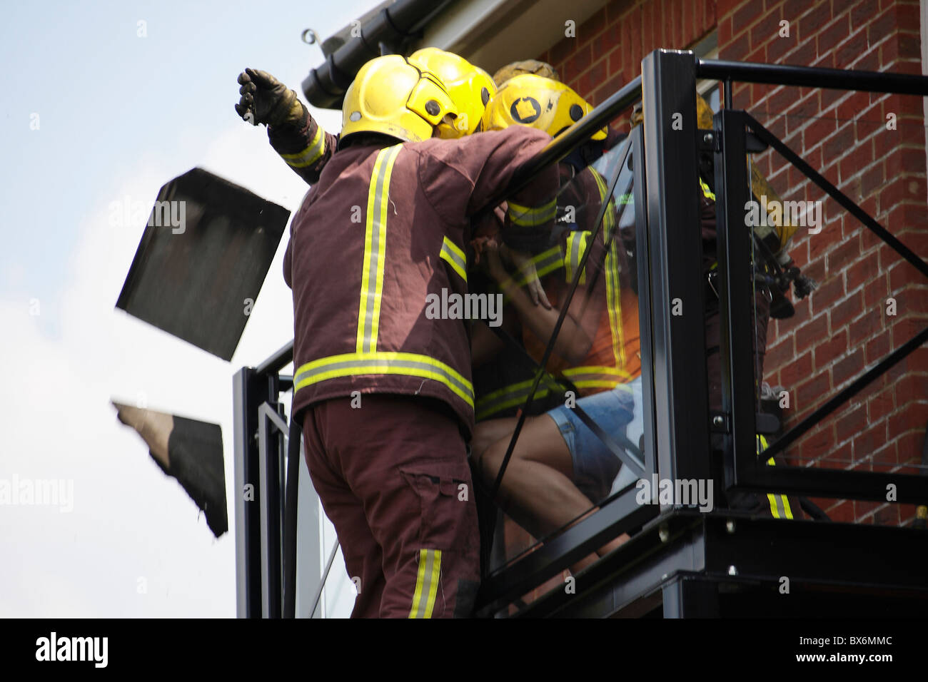 Firefighters rescue trapped family from a fire Stock Photo - Alamy