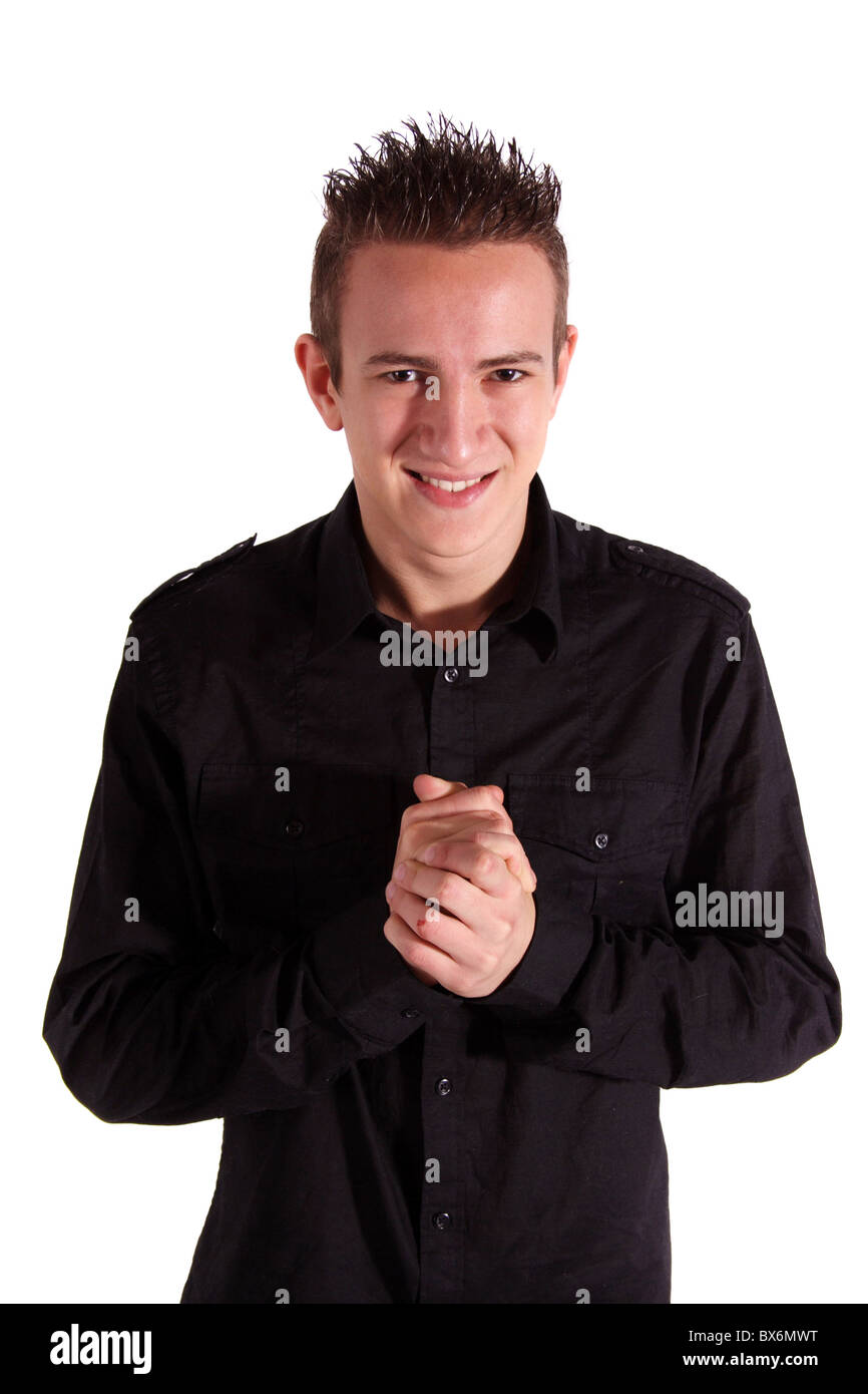 A greedy young man standing in front of white background Stock Photo ...