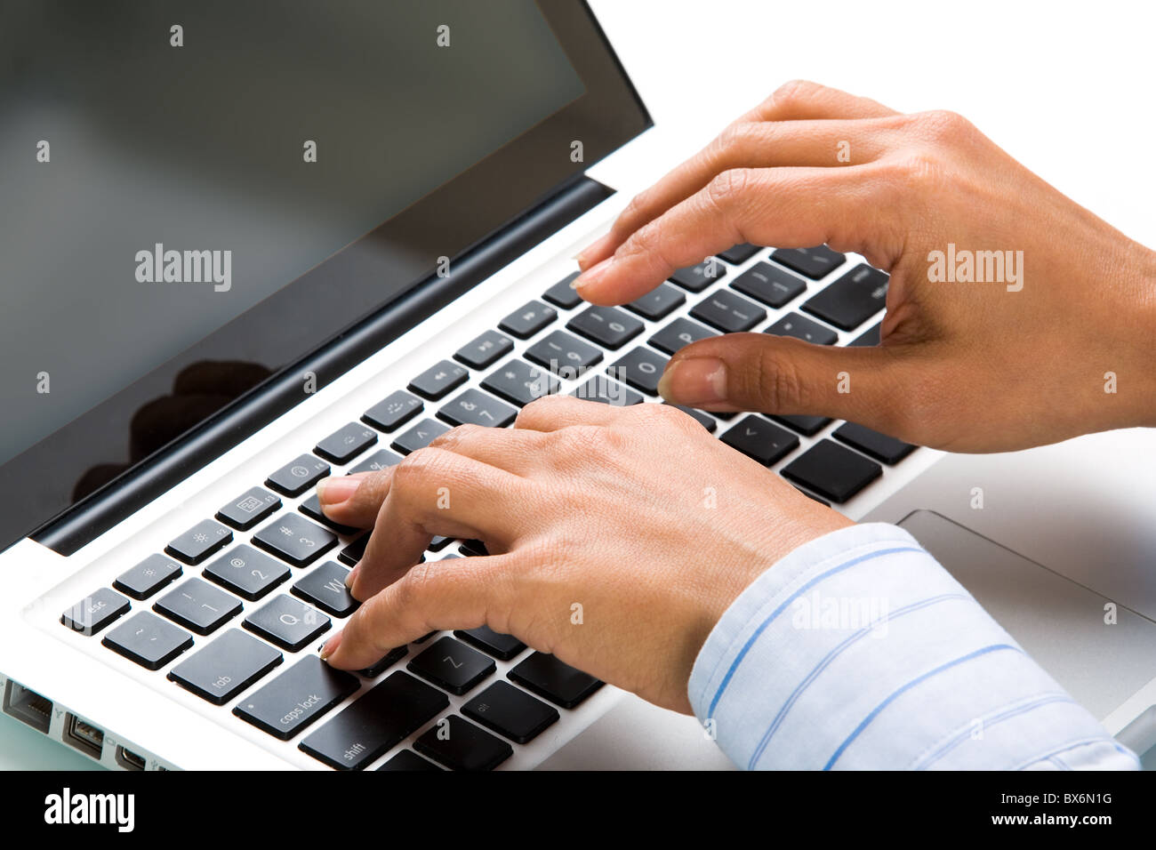 Close-up of female hands over keyboard of laptop during computer work ...
