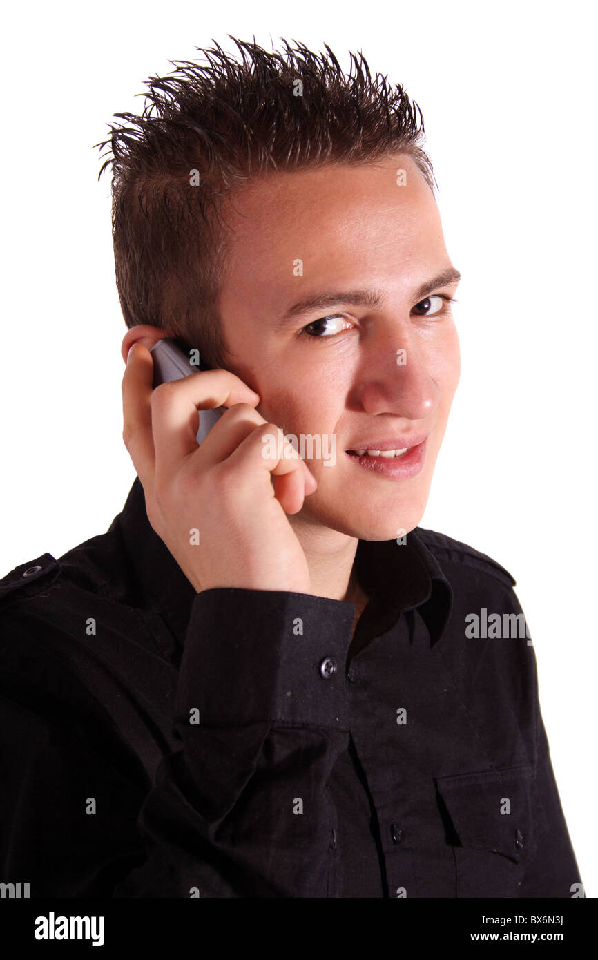 A young handsome man gives someone a call. All isolated on white ...