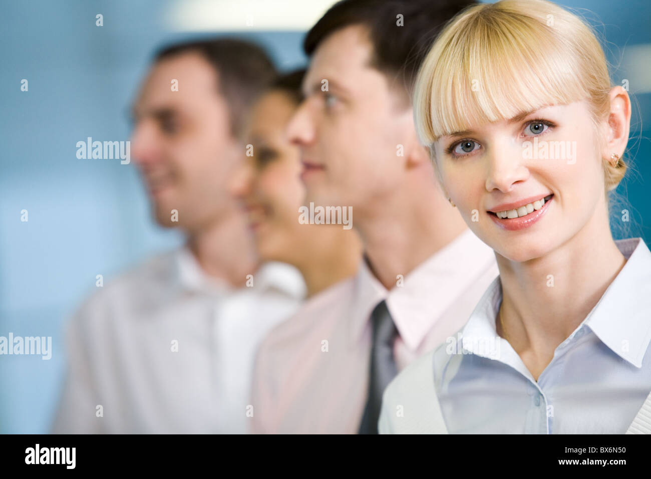 Image of business group standing in line with pretty female in front ...