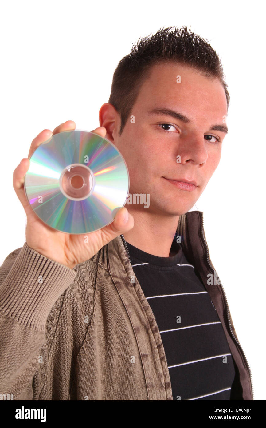 A handsome young man holding a cd or dvd. All isolated on white ...