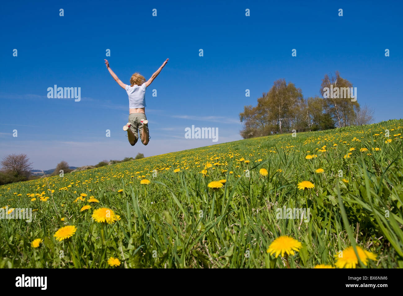 young female having fun on flowery meadow Stock Photo - Alamy