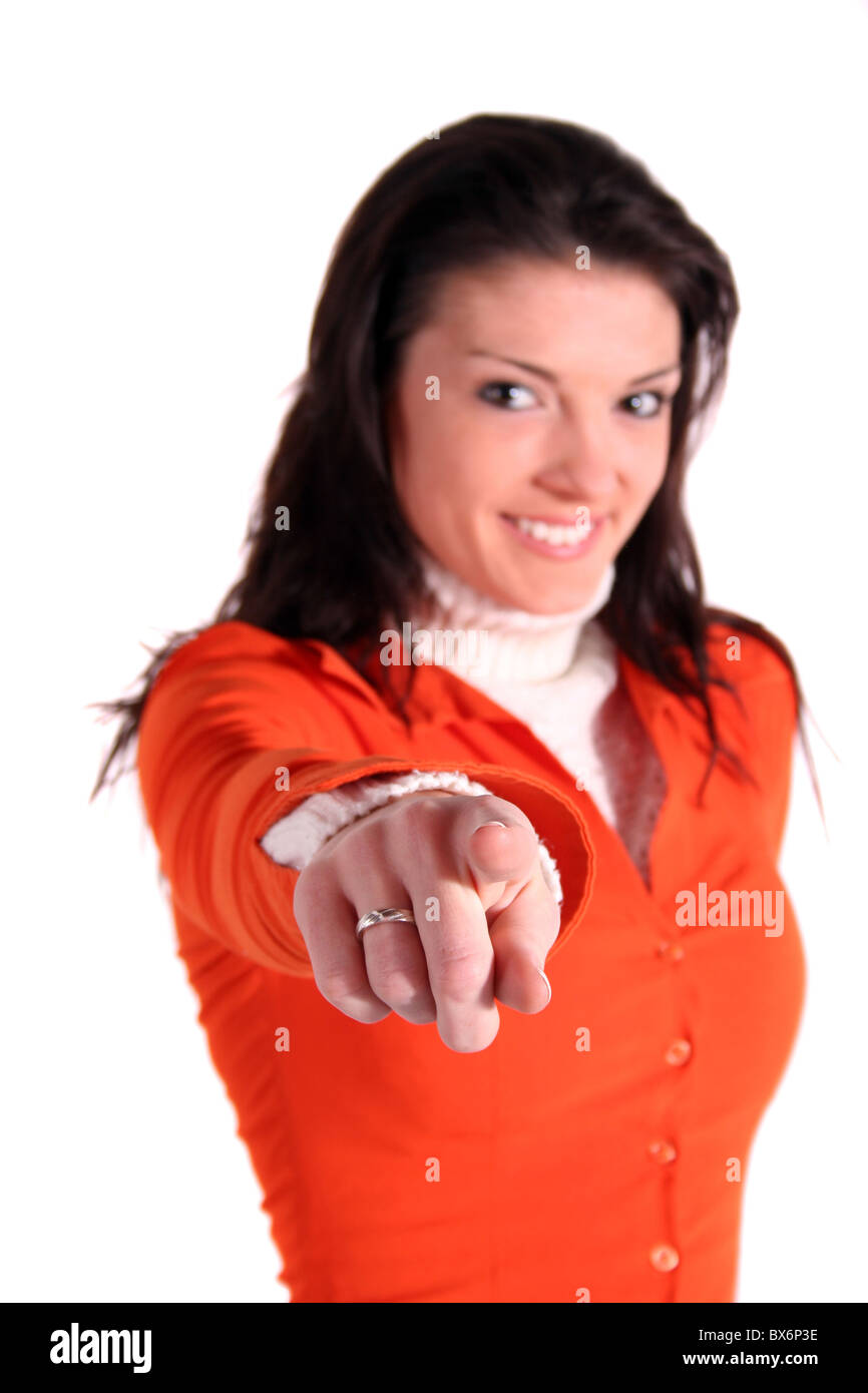 An attractive young woman pointing at someone. All isolated on white ...