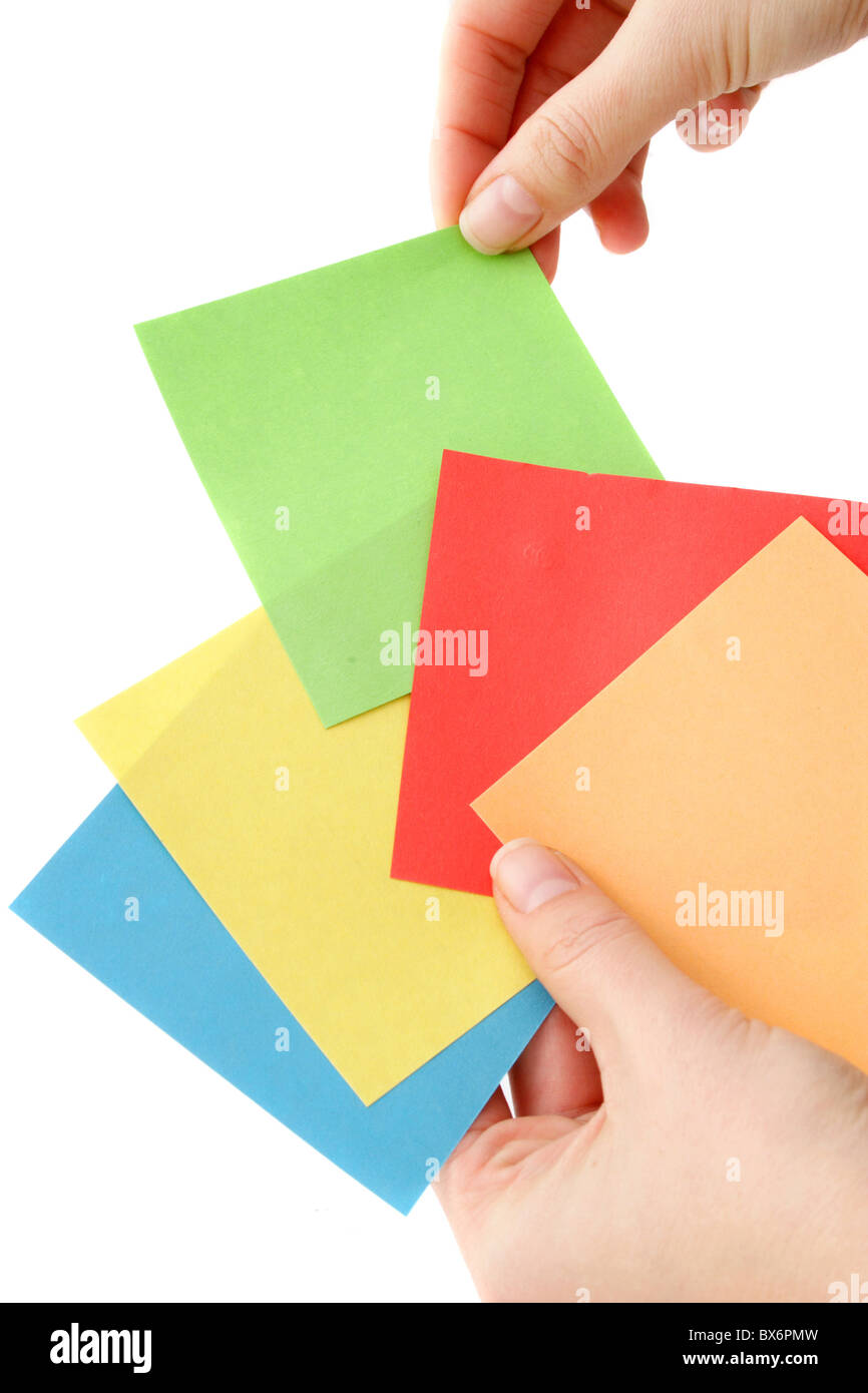 A human hand picks a colored note. All isolated on white background ...