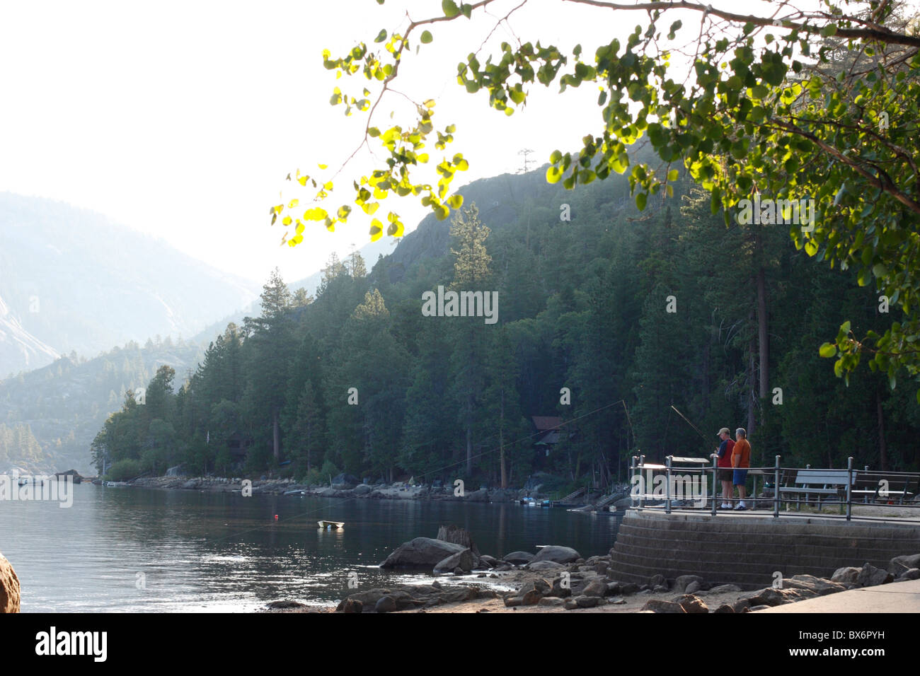 Two men fish off the shore. Pinecrest Lake, Tuolumne county, California ...