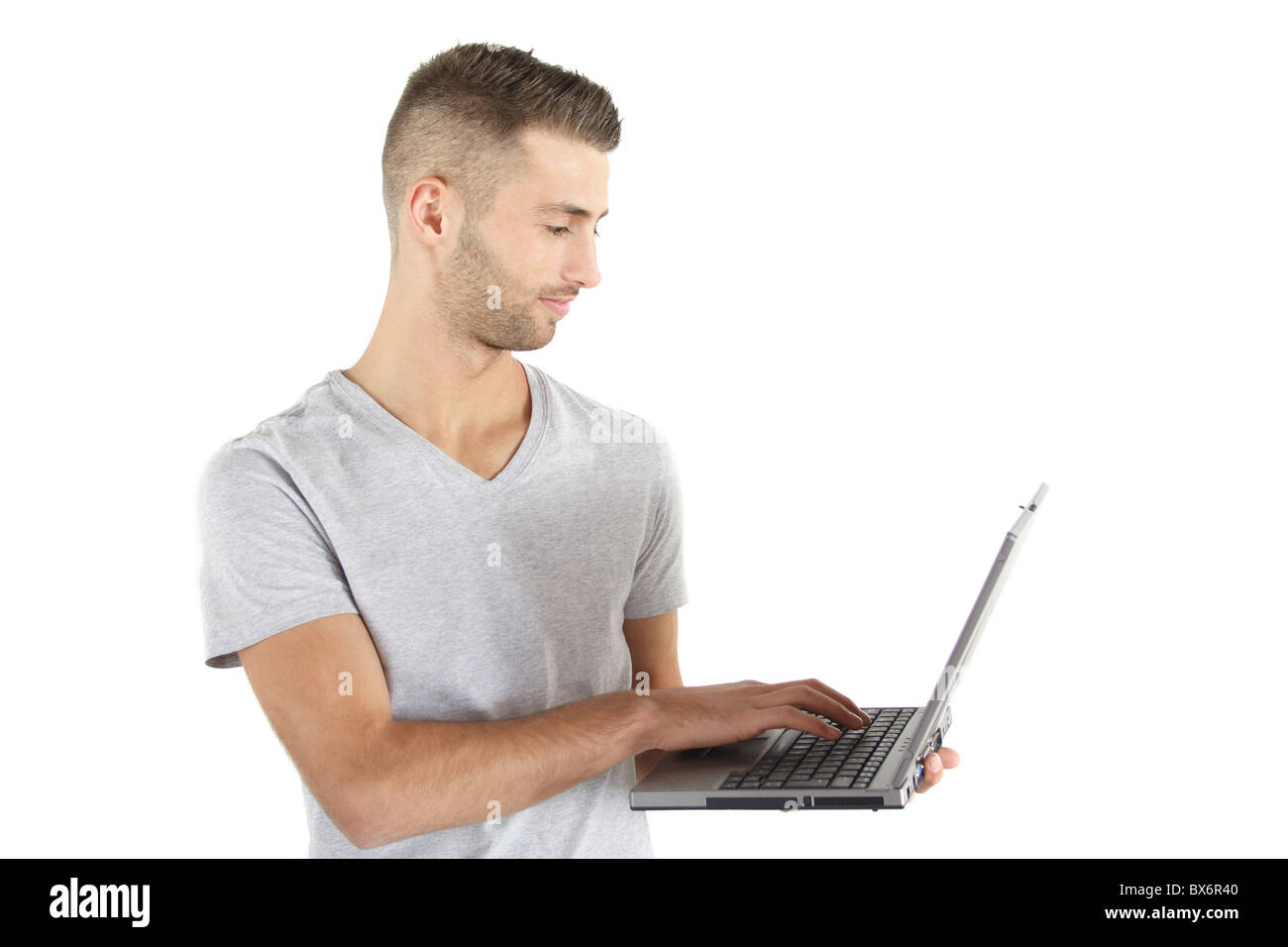 A young handsome man working with his notebook computer. All isolated ...