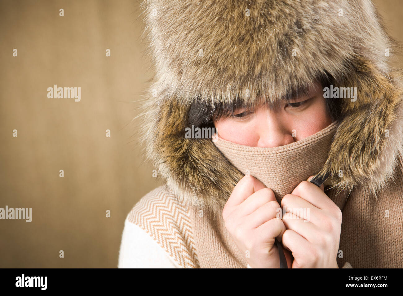 Portrait of cold man in fur hat and knitted scarf warming up Stock ...