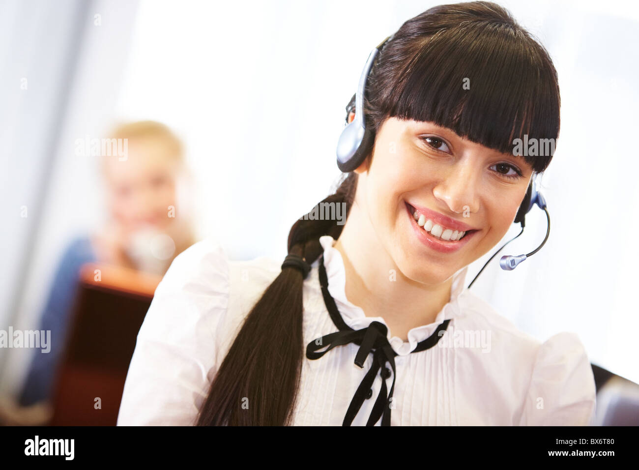 Pretty operator speaking on headphone in the office Stock Photo - Alamy