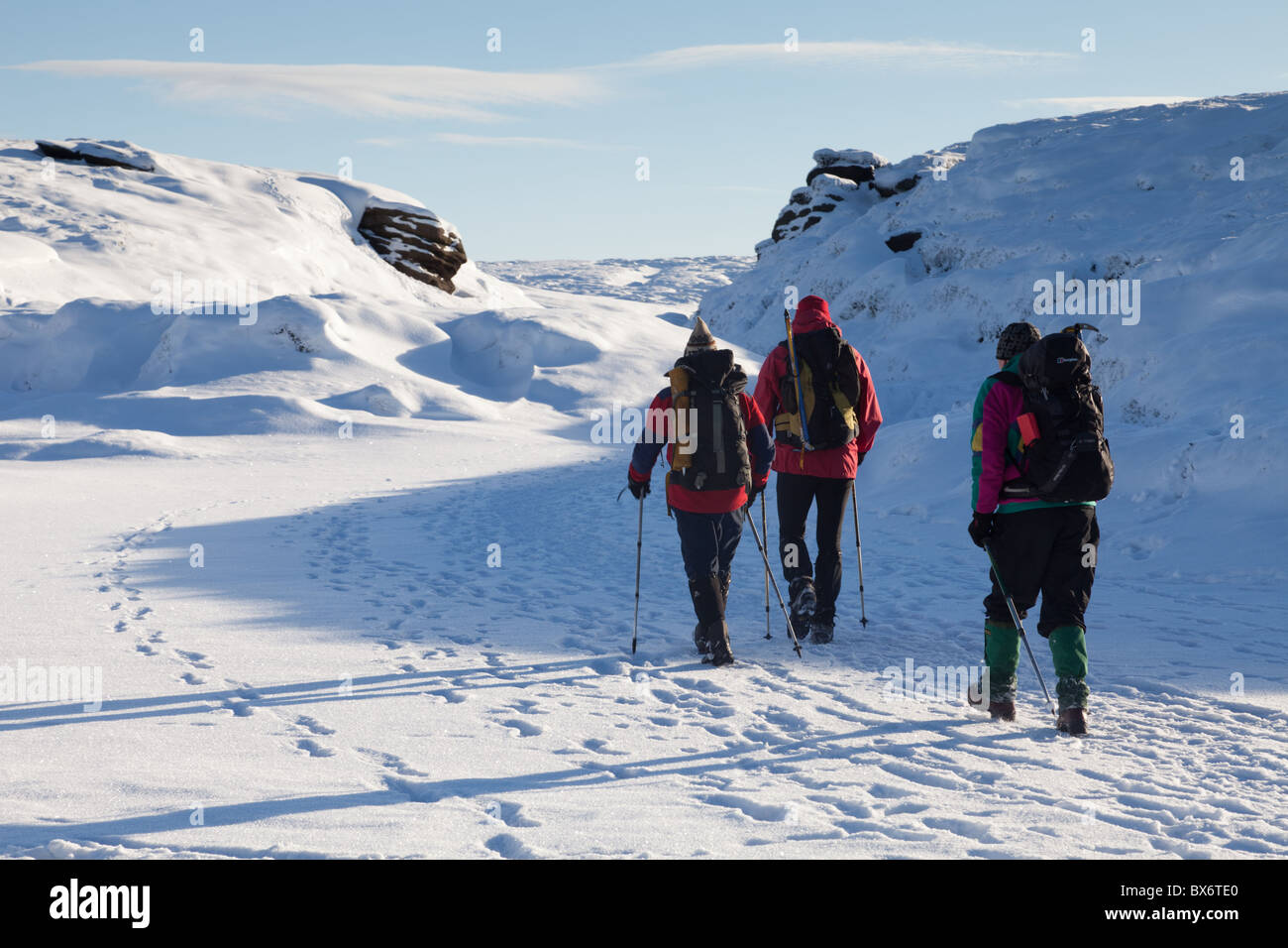Walkers on the Kinder River in winter on Kinder Scout in the Dark Peak ...